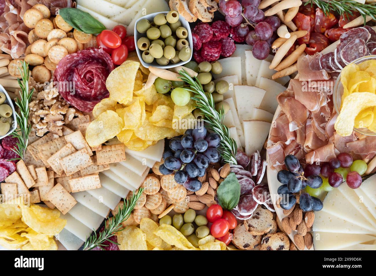 Charcuterie board featuring a variety of cured meats, cheeses, crackers ...