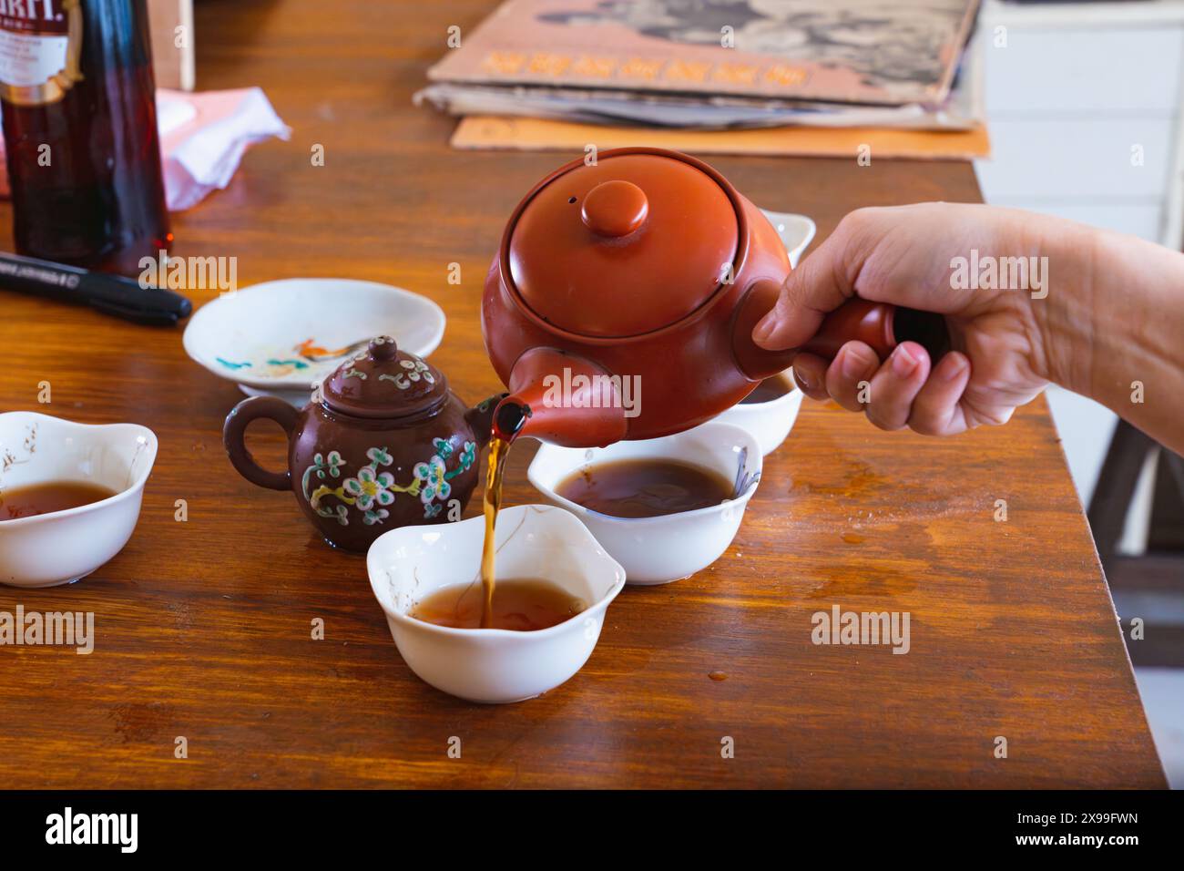 Very Old Chinese TeaPot with Tea Pouring in a small bowls Tea Tasting ...