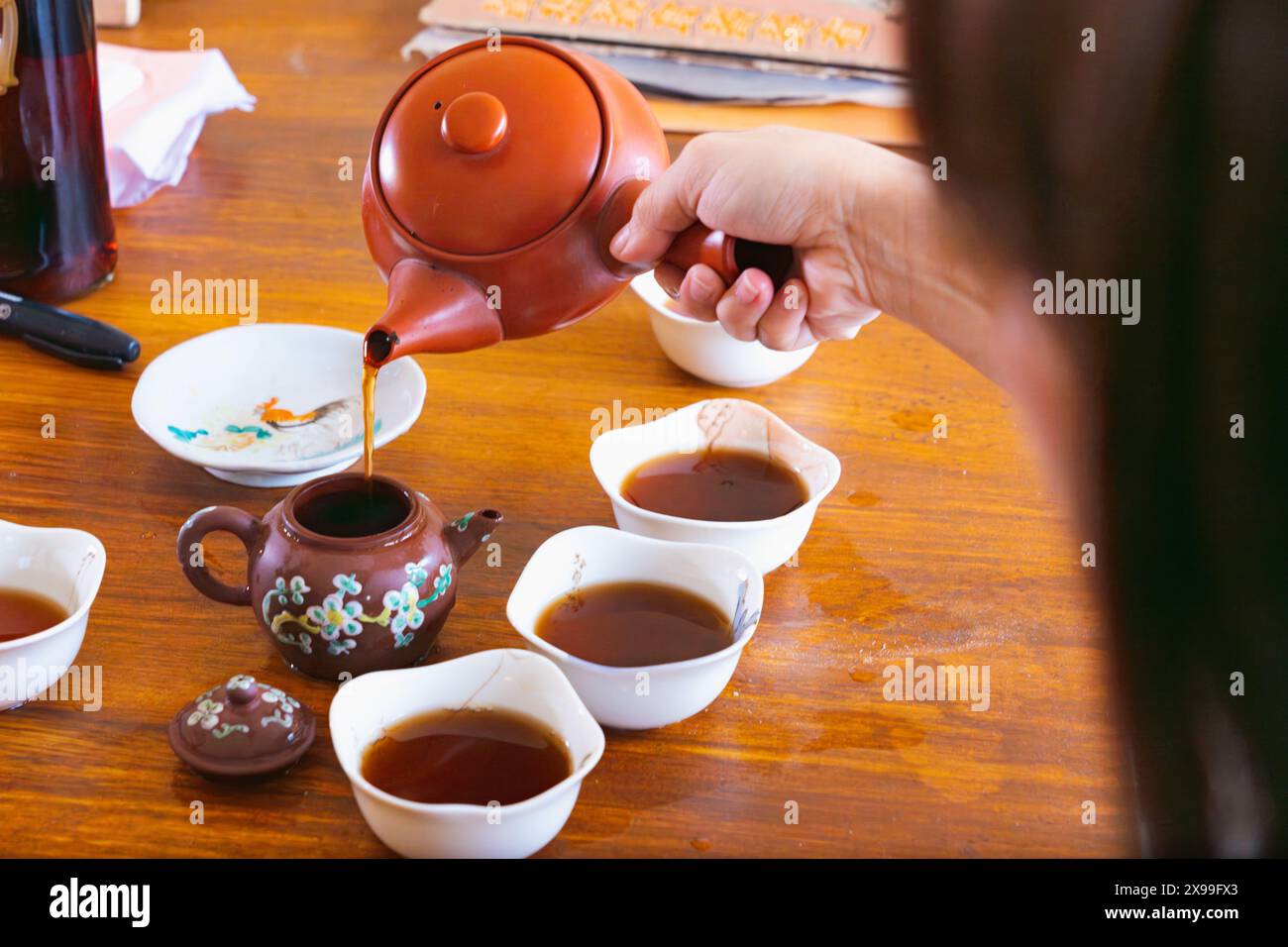 Very Old Chinese TeaPot with Tea Pouring in a small bowls Tea Tasting ...