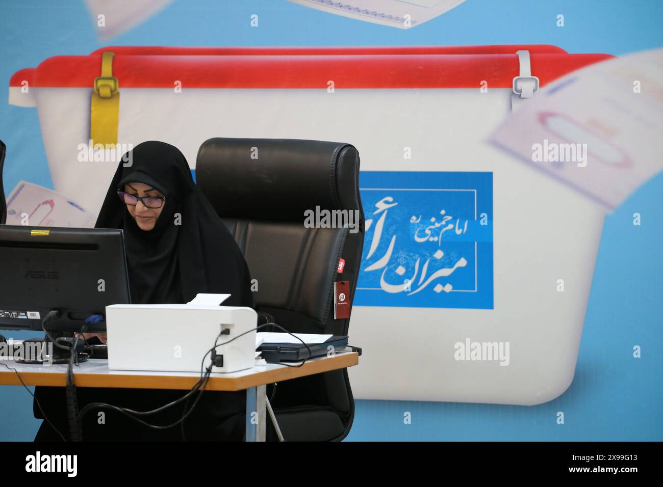 Tehran, Iran. 30th May, 2024. An Iranian veiled electoral official ...
