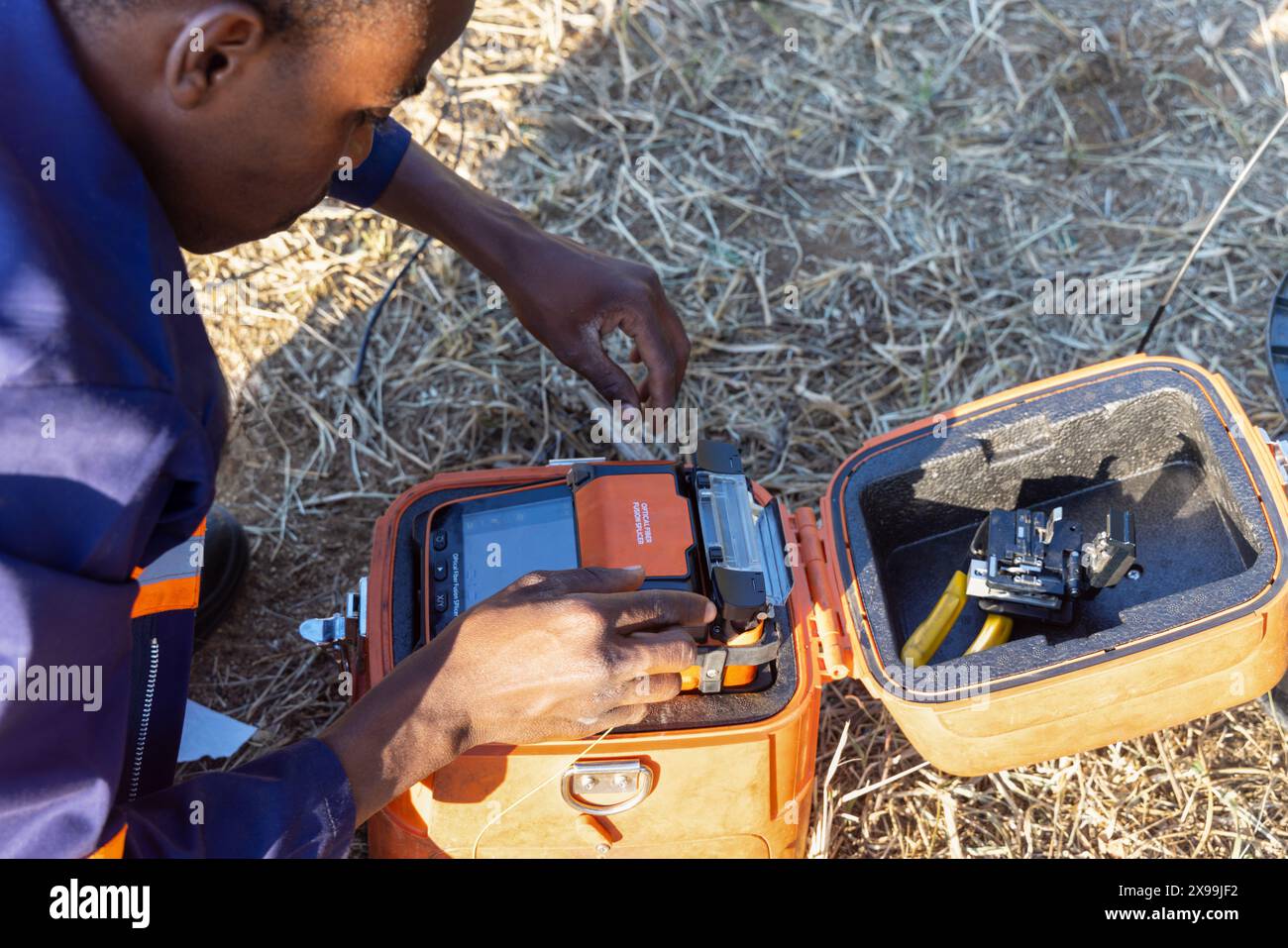 optical fiber fusion splicer, african american technician using a ...