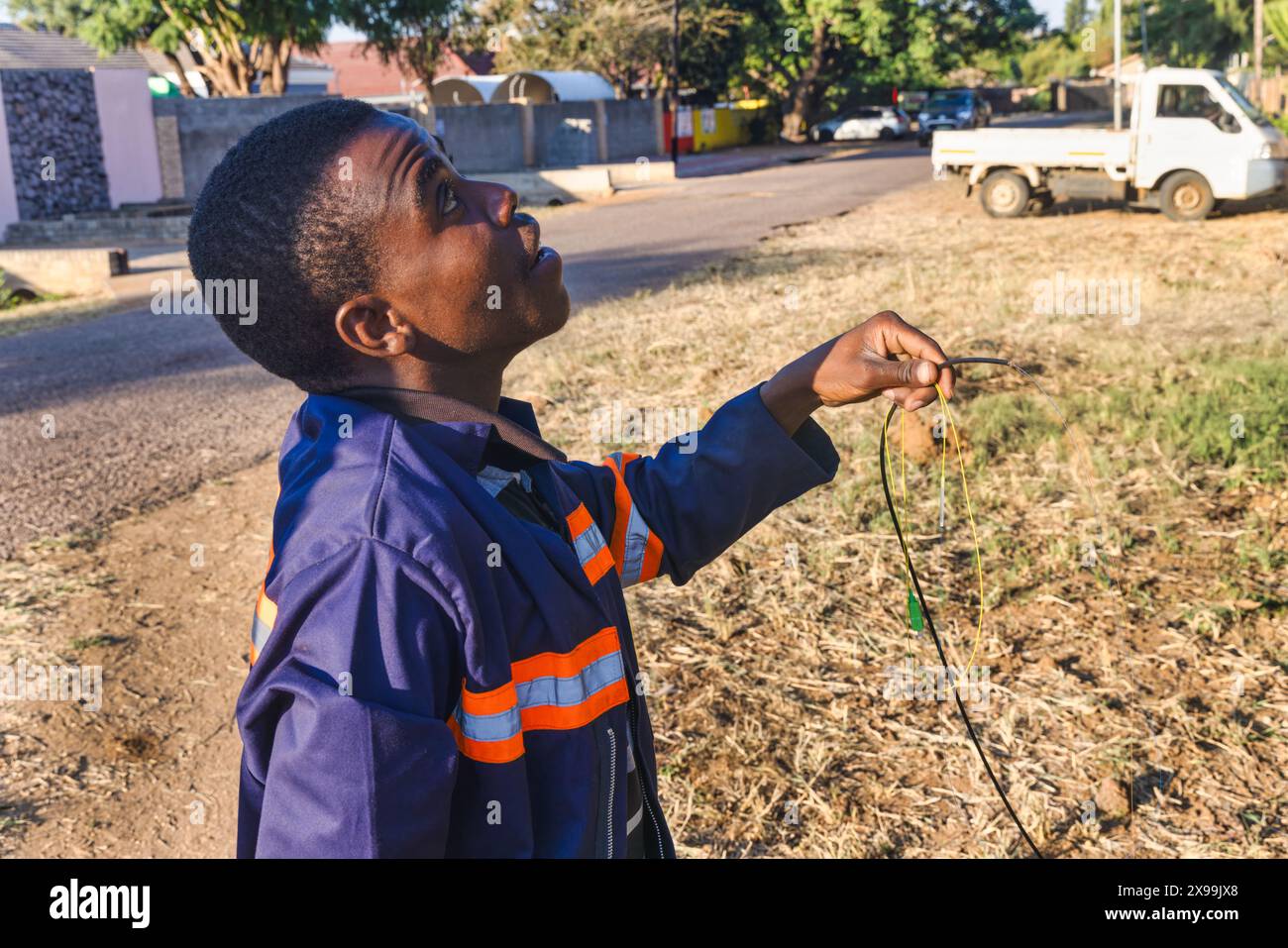 young african man technician, holding fiber optic cable in his hand ...