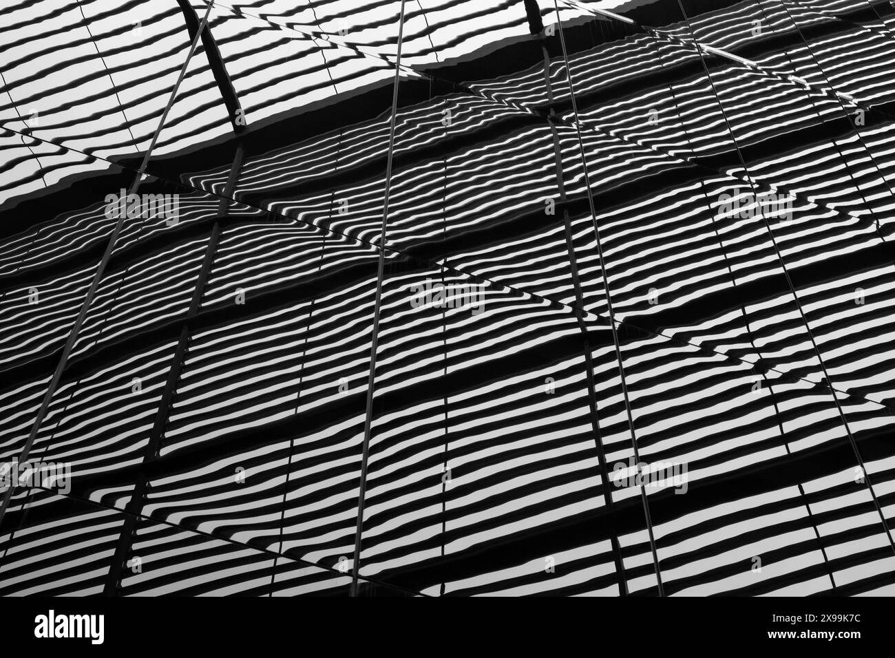 Low angle perspective view of abstract mirrored glass facade ...