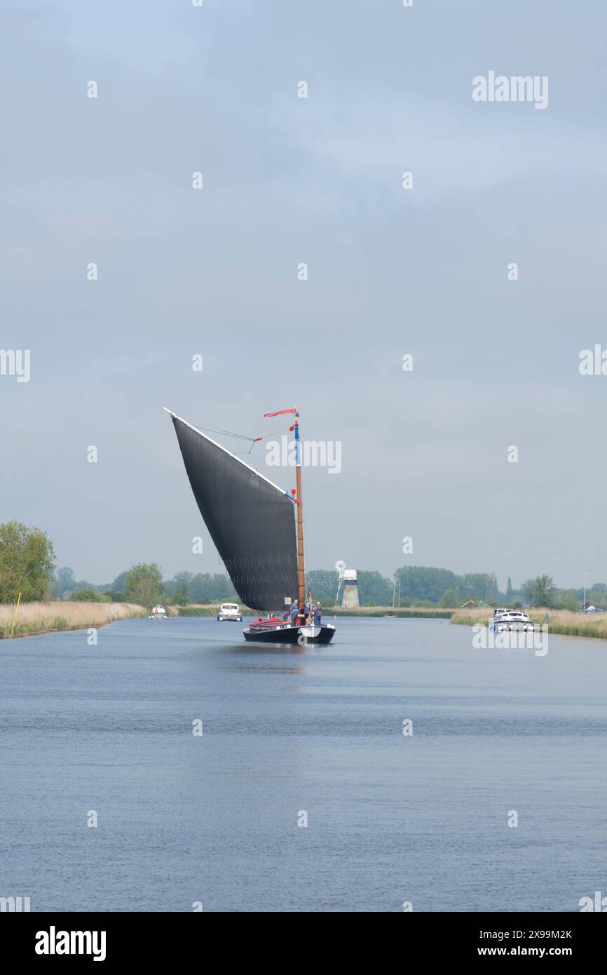 people sailing a traditional wherry sailing boat on the River Bure ...