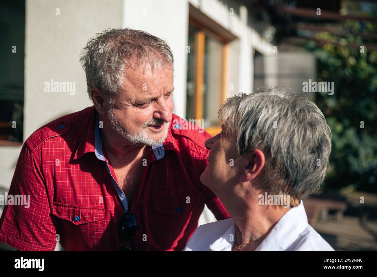 Close-up of a senior couple engaging in a warm, personal discussion ...