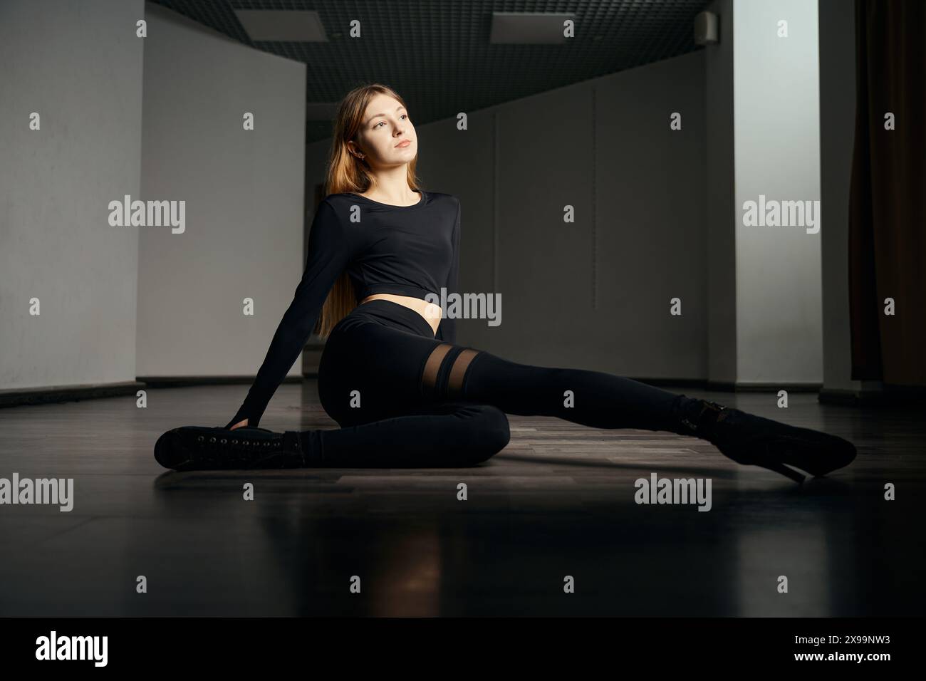 Stiletto dancer performing floorwork routine during dance session Stock ...