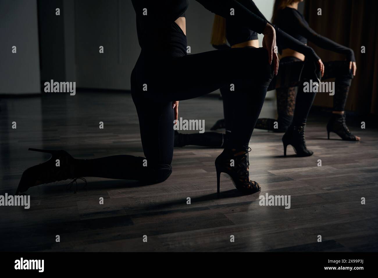 Trio of high heels dancers stretching before dancing Stock Photo - Alamy
