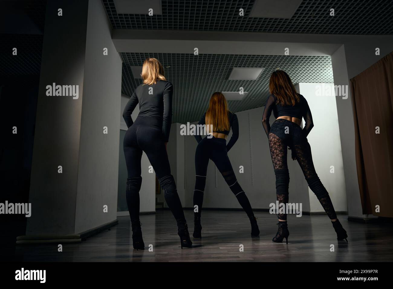 Trio of dancers doing high heels choreography Stock Photo - Alamy