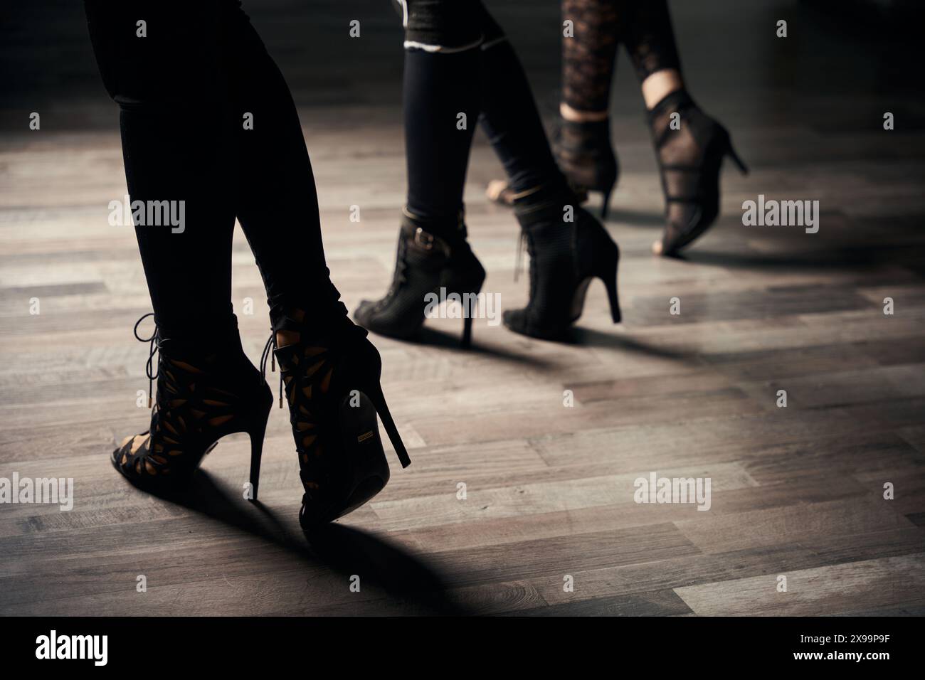 Dancing trio in stilettos striking dance pose Stock Photo - Alamy