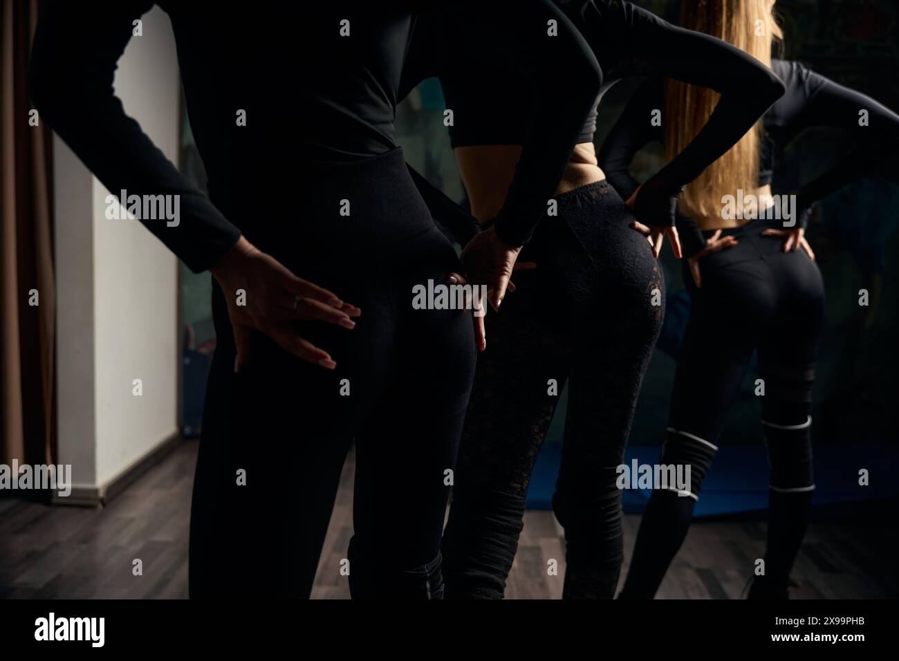 Three female dancers practicing dance moves in choreographic studio ...
