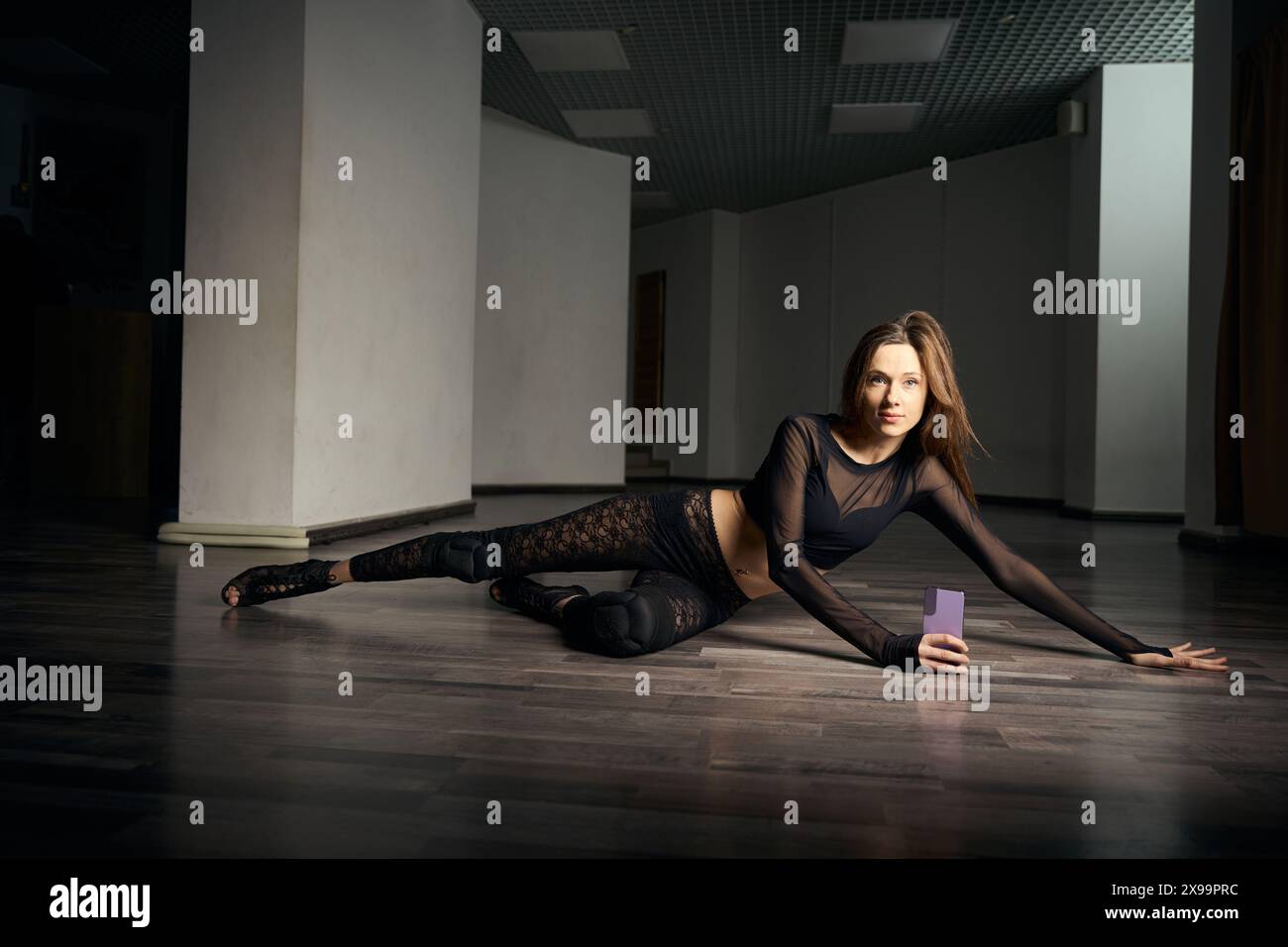 Confident stiletto dancer performing floorwork routine in studio Stock ...