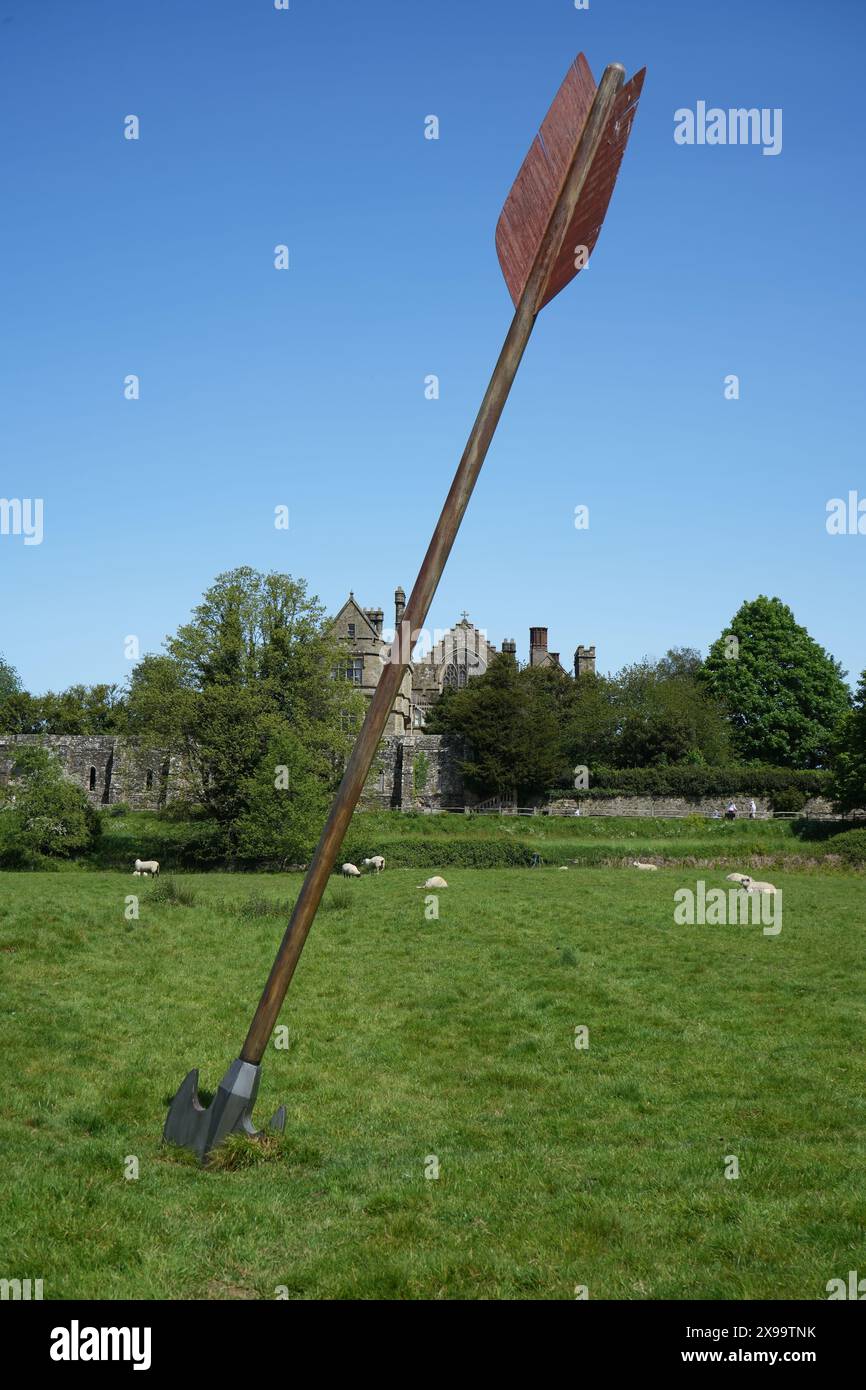 A giant arrow at The Battle of Hastings site with Battle Abbey behind ...
