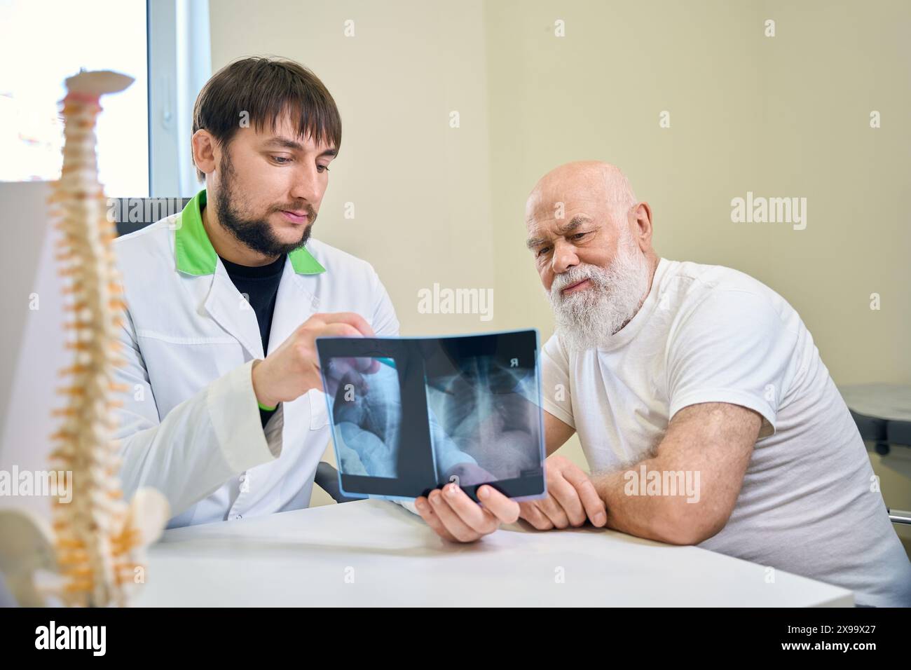 Two men looking at a patient chest x-ray Stock Photo - Alamy