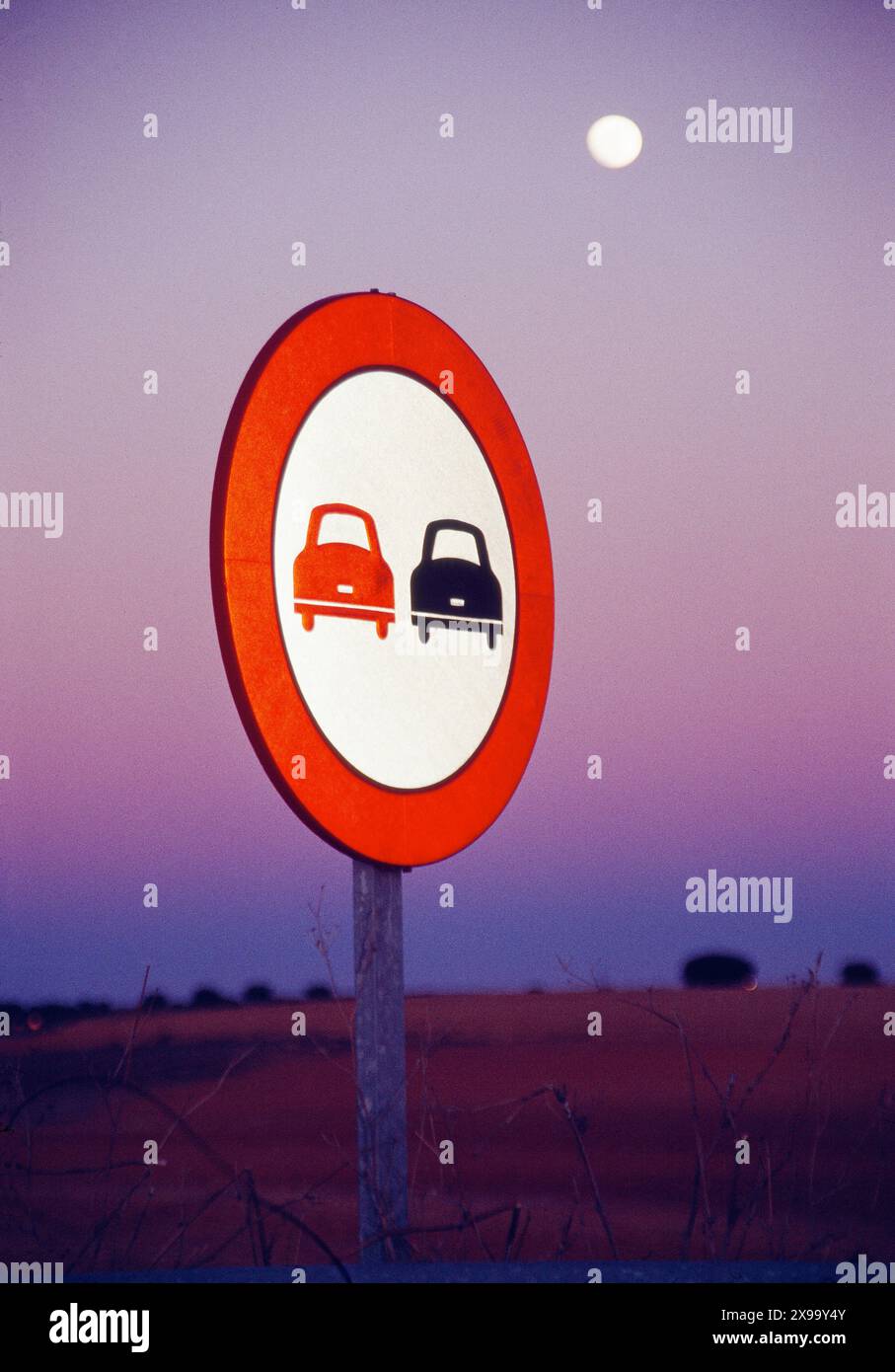 Night view of a No overtaking road sign Stock Photo - Alamy