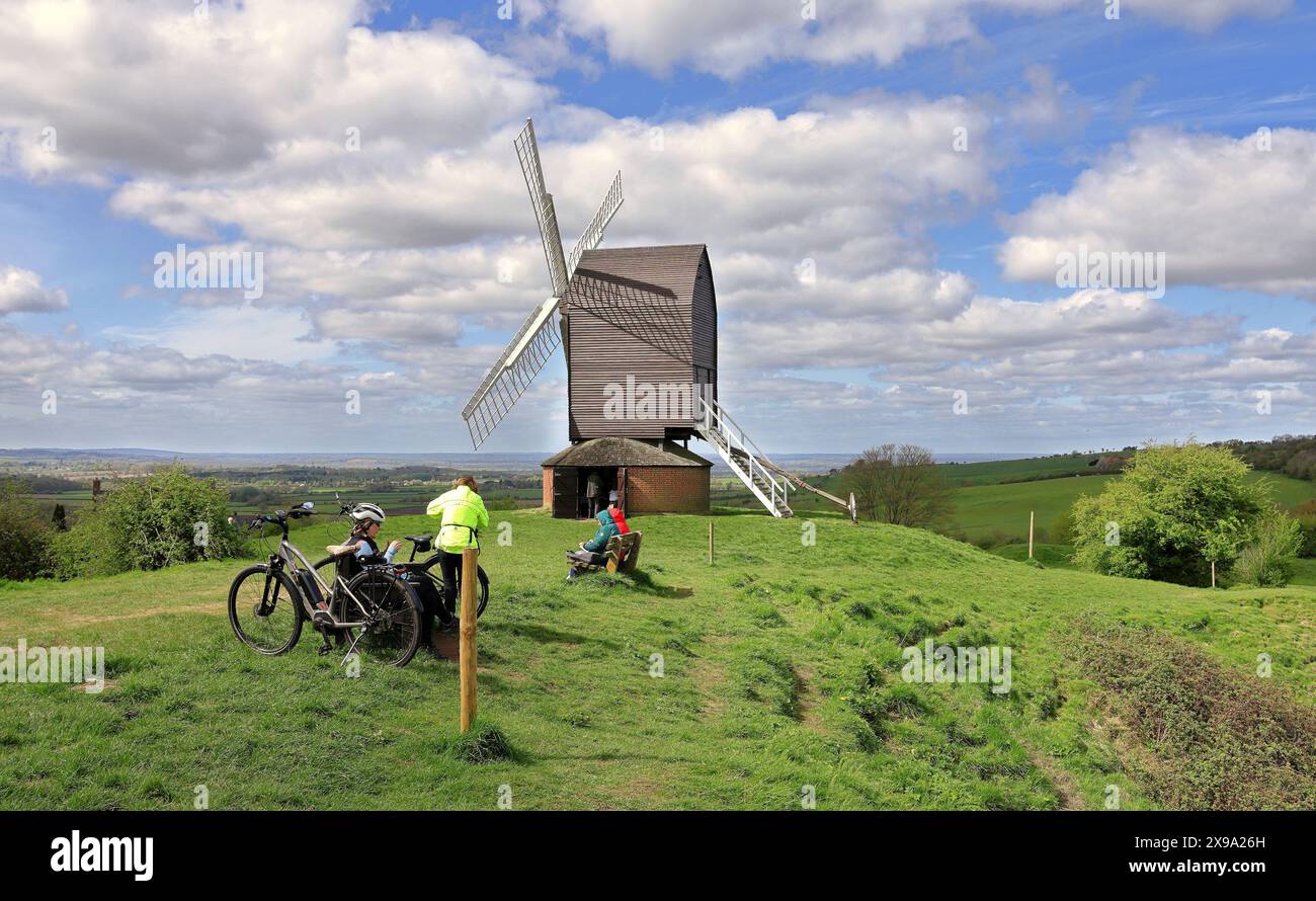Brill Post Mill Windmill in Buckinghamshire UK, with cyclists seated on ...