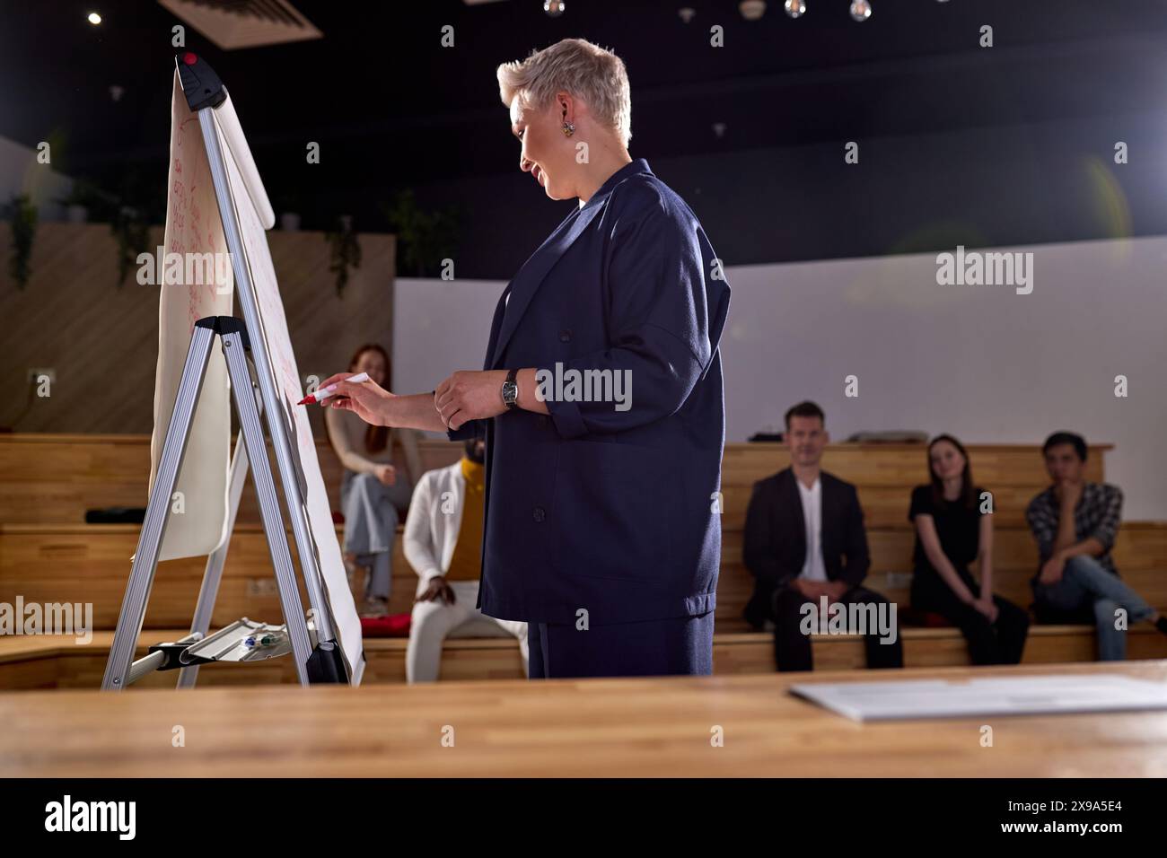 Female College Professor Gives Lecture to Classroom Full of Multi ...