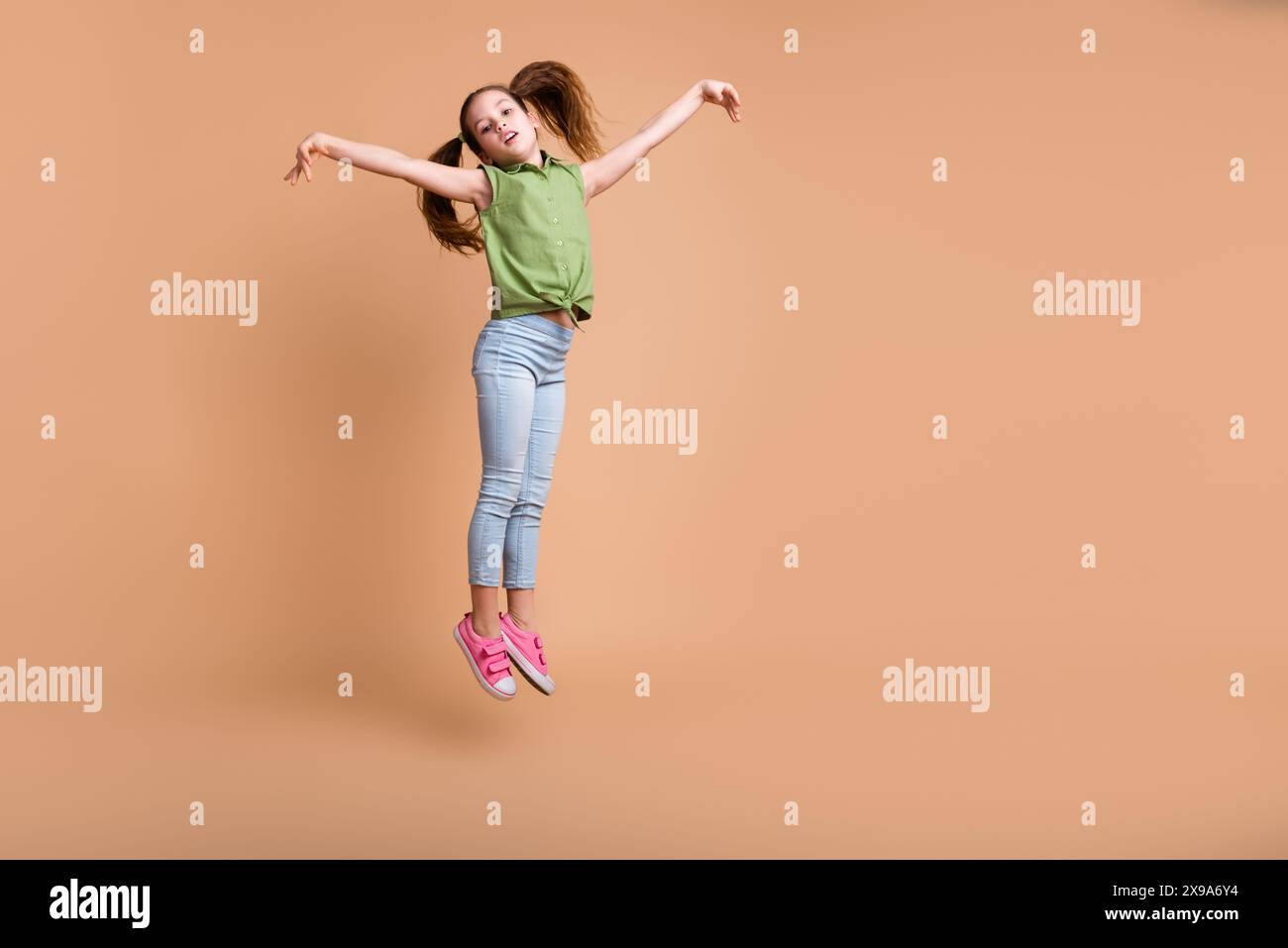 Photo of graceful girl kid jump dance move pose isolated pastel color ...