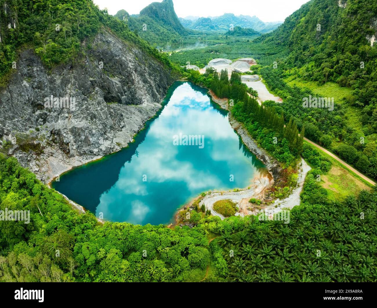 Aerial view of amazing pond in tropical rainforest with mountain rocks ...