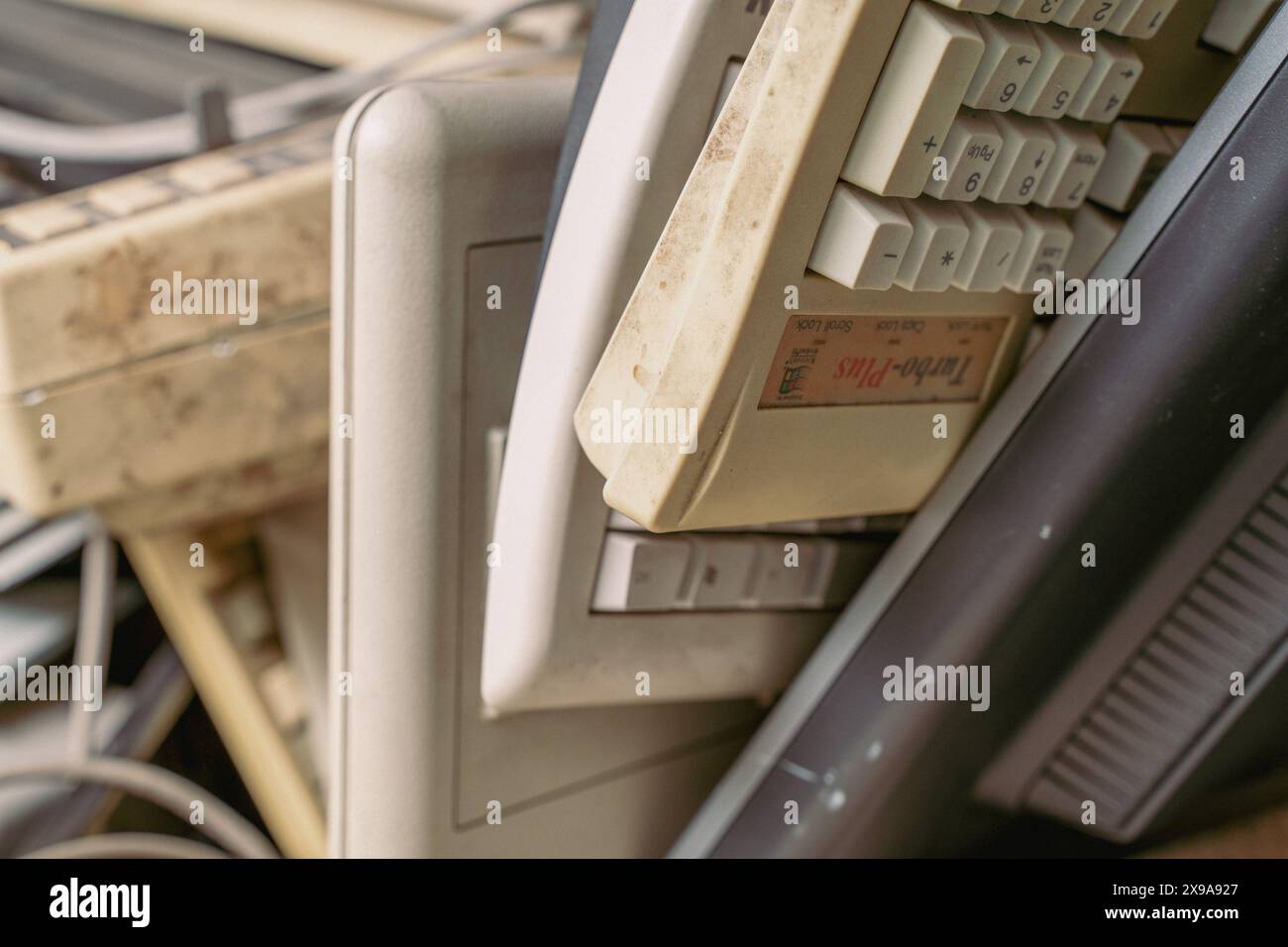 Old and broken computer equipment, monitors and keyboards are piled up ...