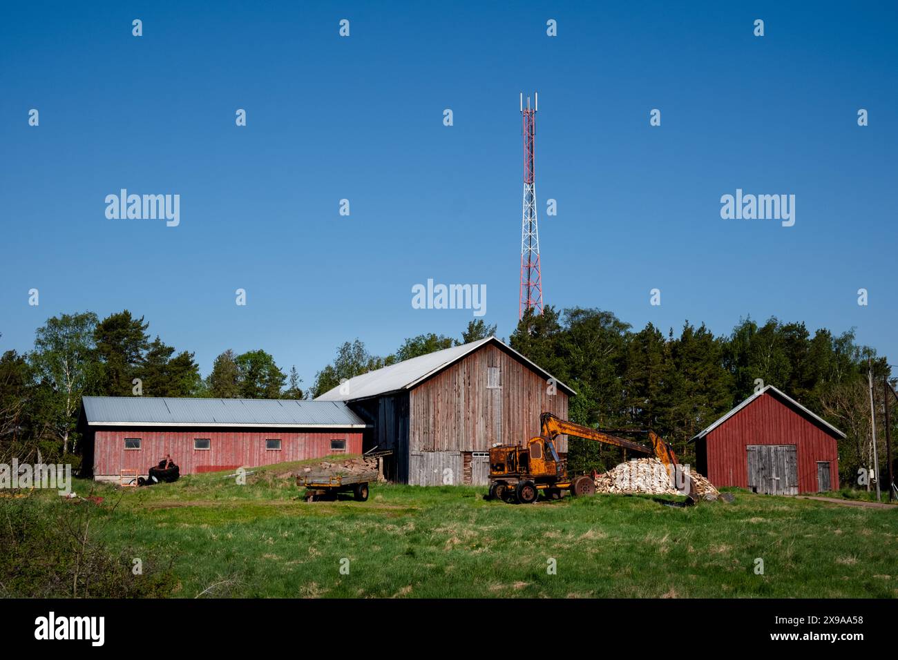 FARMYARD, LUMPARLAND, ÅLAND: Old barns, sheds a woodpile and rusty ...