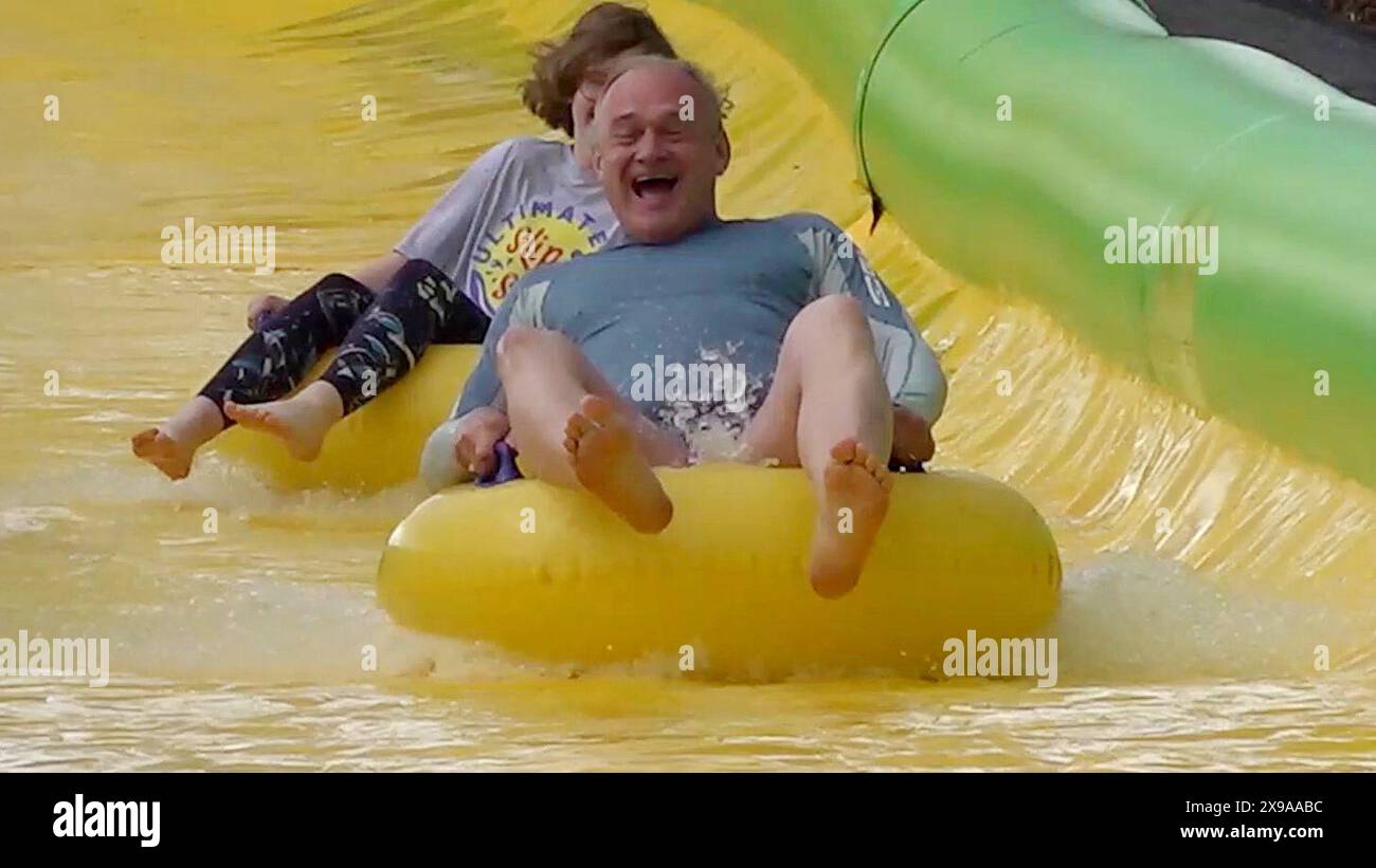 Liberal Democrat leader Sir Ed Davey rides down the Ultimate Slip n ...