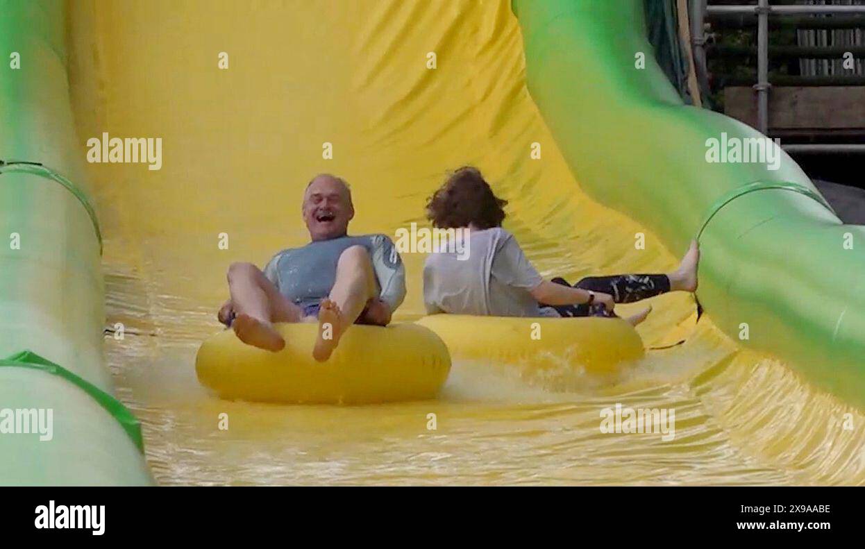 Liberal Democrat leader Sir Ed Davey rides down the Ultimate Slip n ...