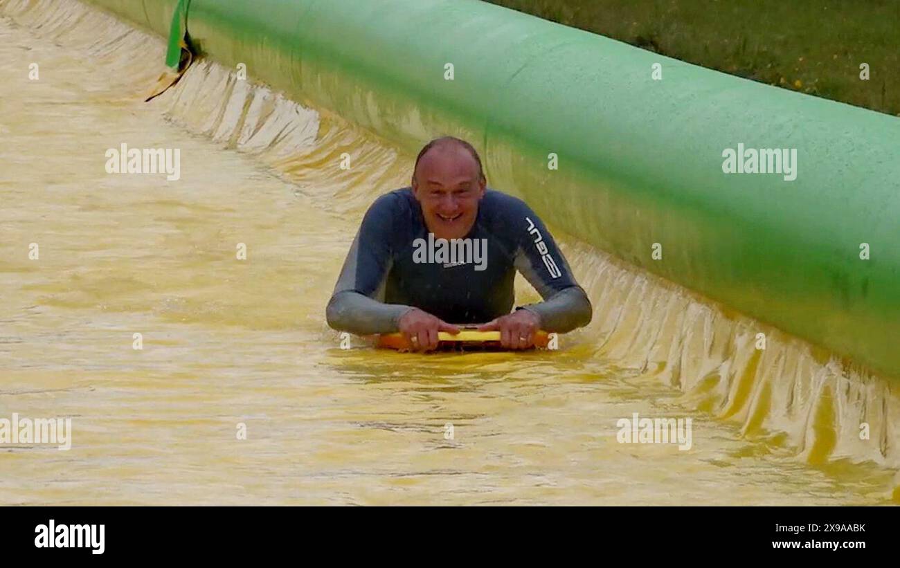 Liberal Democrat leader Sir Ed Davey rides down the Ultimate Slip n ...