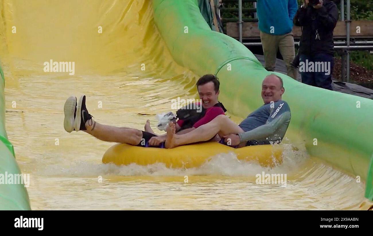 Liberal Democrat leader Sir Ed Davey rides down the Ultimate Slip n ...