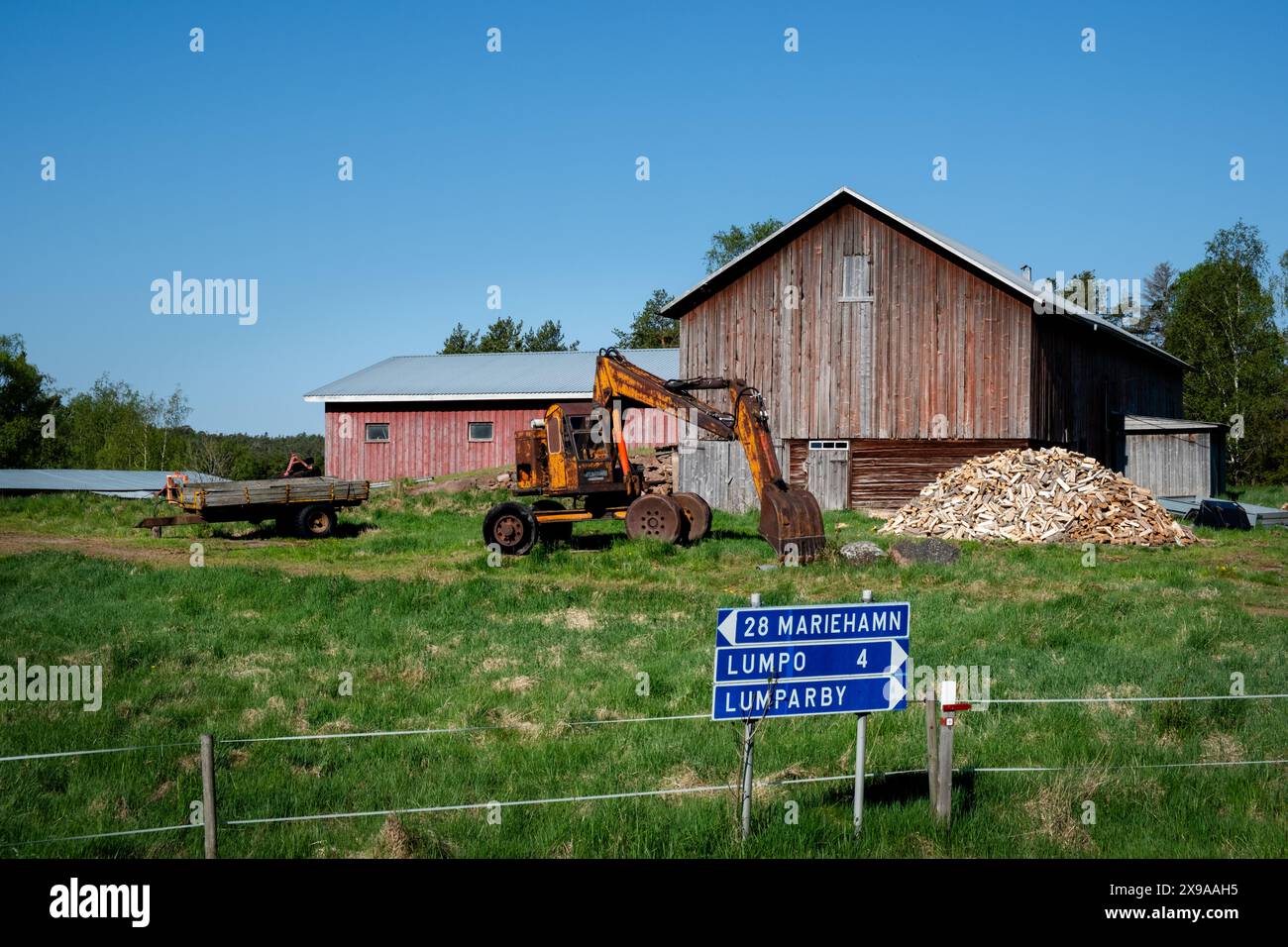 FARMYARD, LUMPARLAND, ÅLAND: Old barns, sheds a woodpile and rusty ...