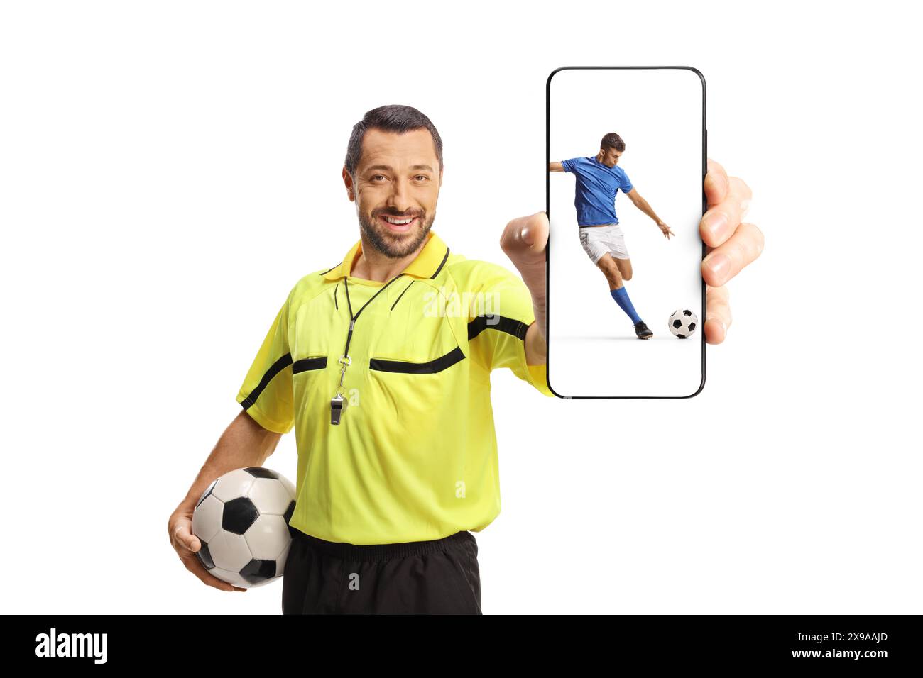 Football referee holding a ball and showing a smartphone with a ...