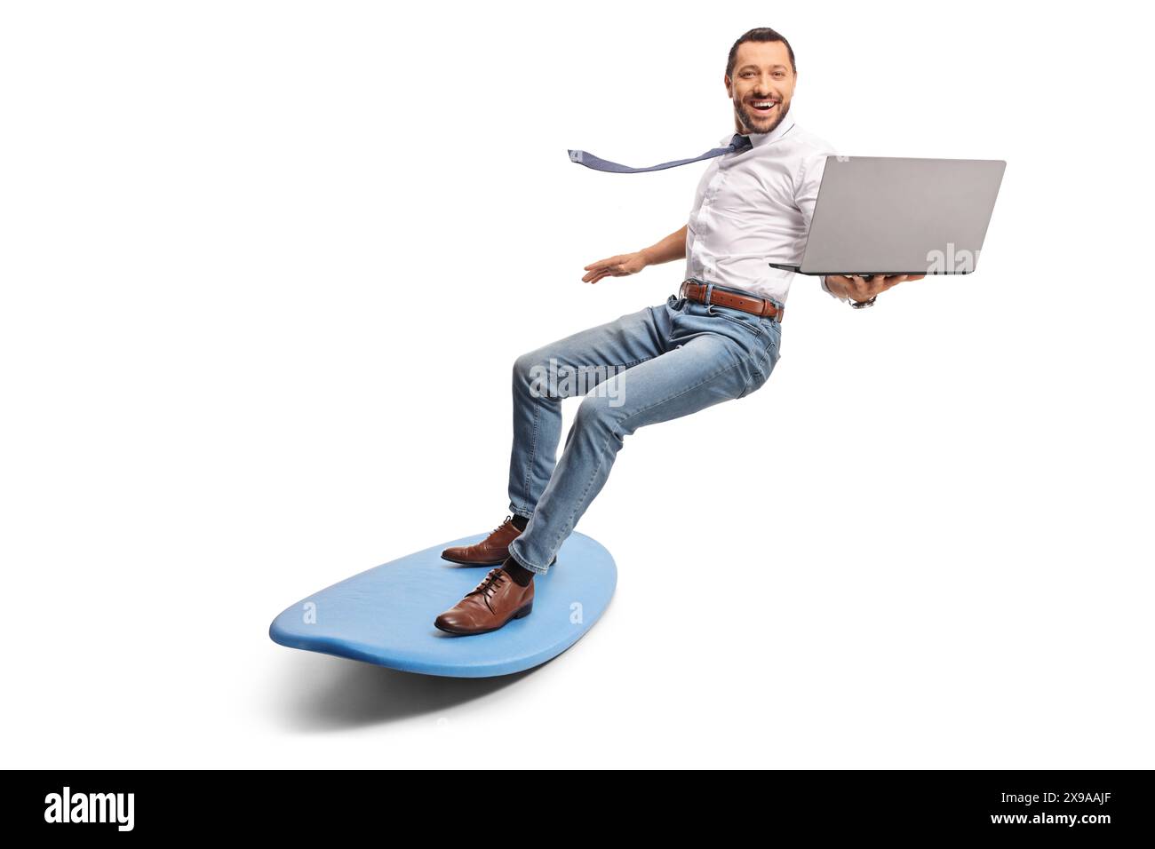 Man holding a laptop computer and riding a surfboard isolated on white ...