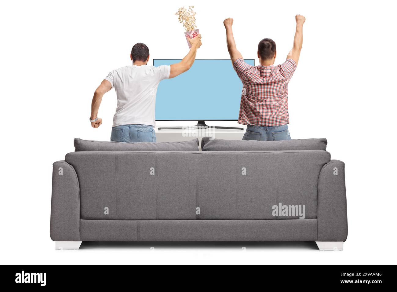 Rear view shot of young men watching football match on tv and cheering ...