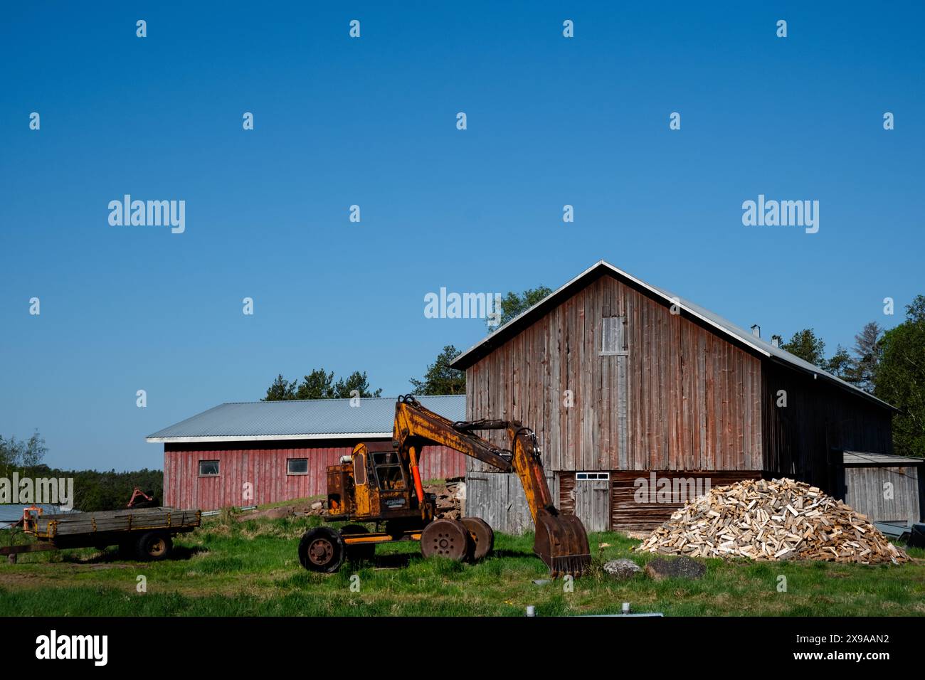 FARMYARD, LUMPARLAND, ÅLAND: Old barns, sheds a woodpile and rusty ...