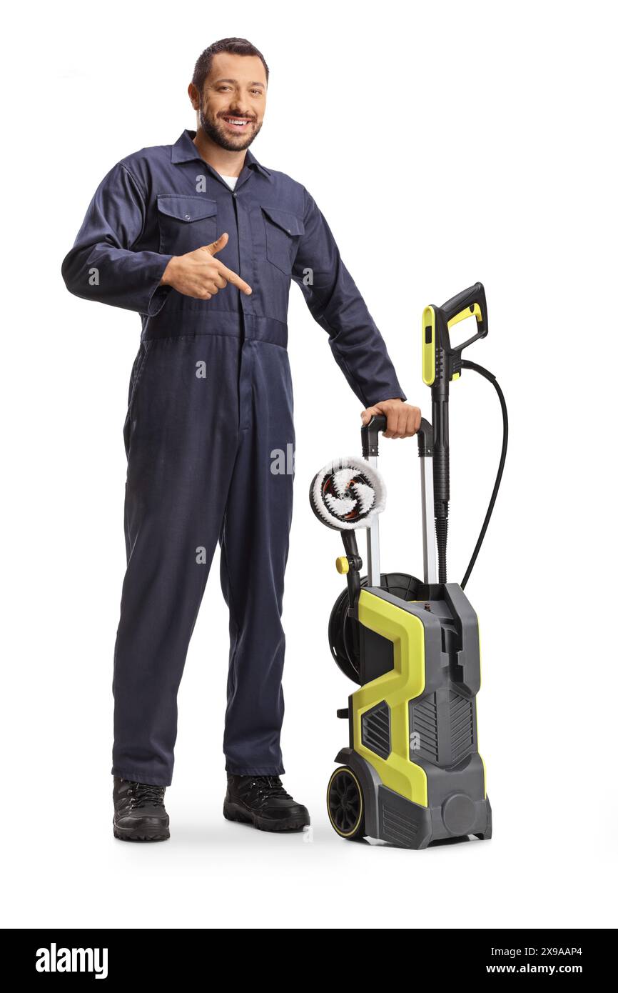 Worker in a uniform pointing at a high pressure washer machine isolated ...