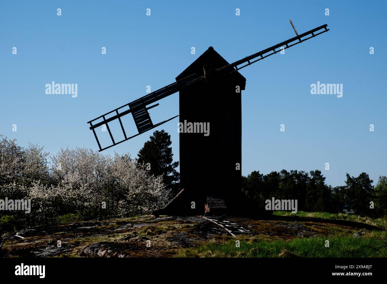 LUMPARLAND, ÅLAND: A wind damaged windmill in silhouette on a farm in ...