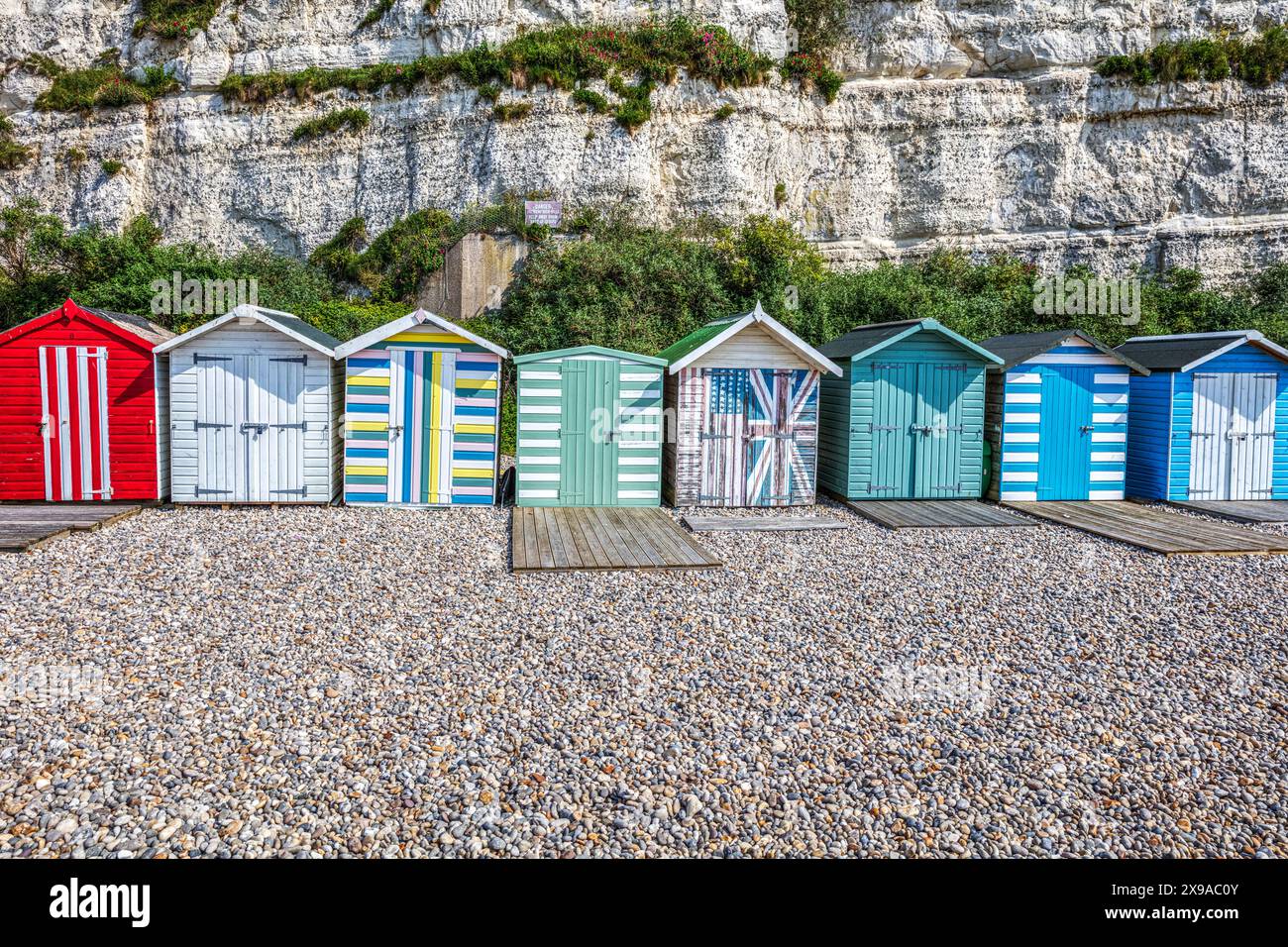Row Of Beach Huts on Beer Beach, Devon, UK A row of colourful beach ...
