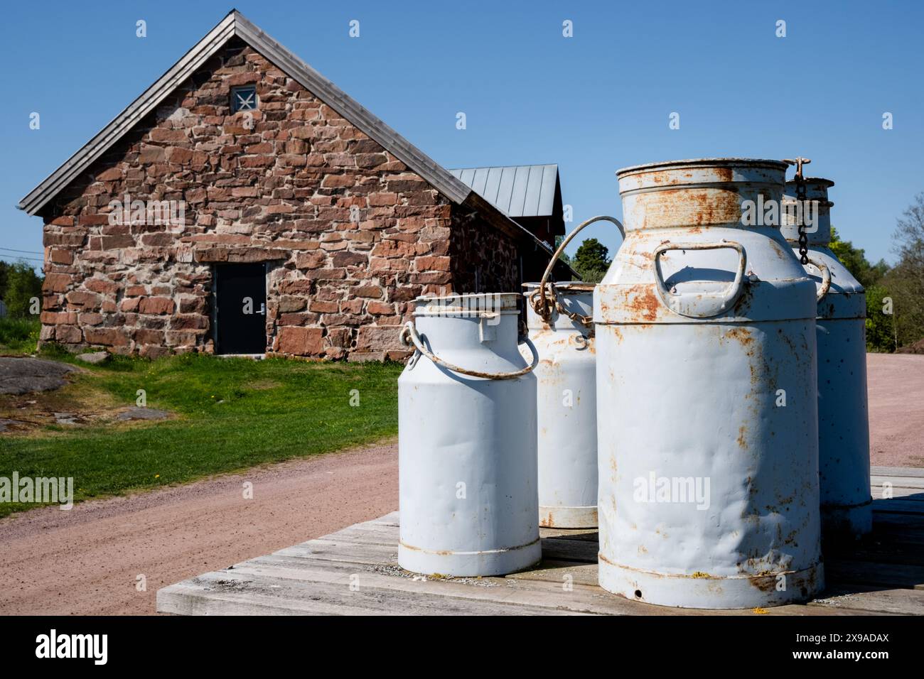 MILK CHURN, TRADITONAL NORDIC FARM, ÖNNINGEBY, ÅLAND: Milk churns on a ...