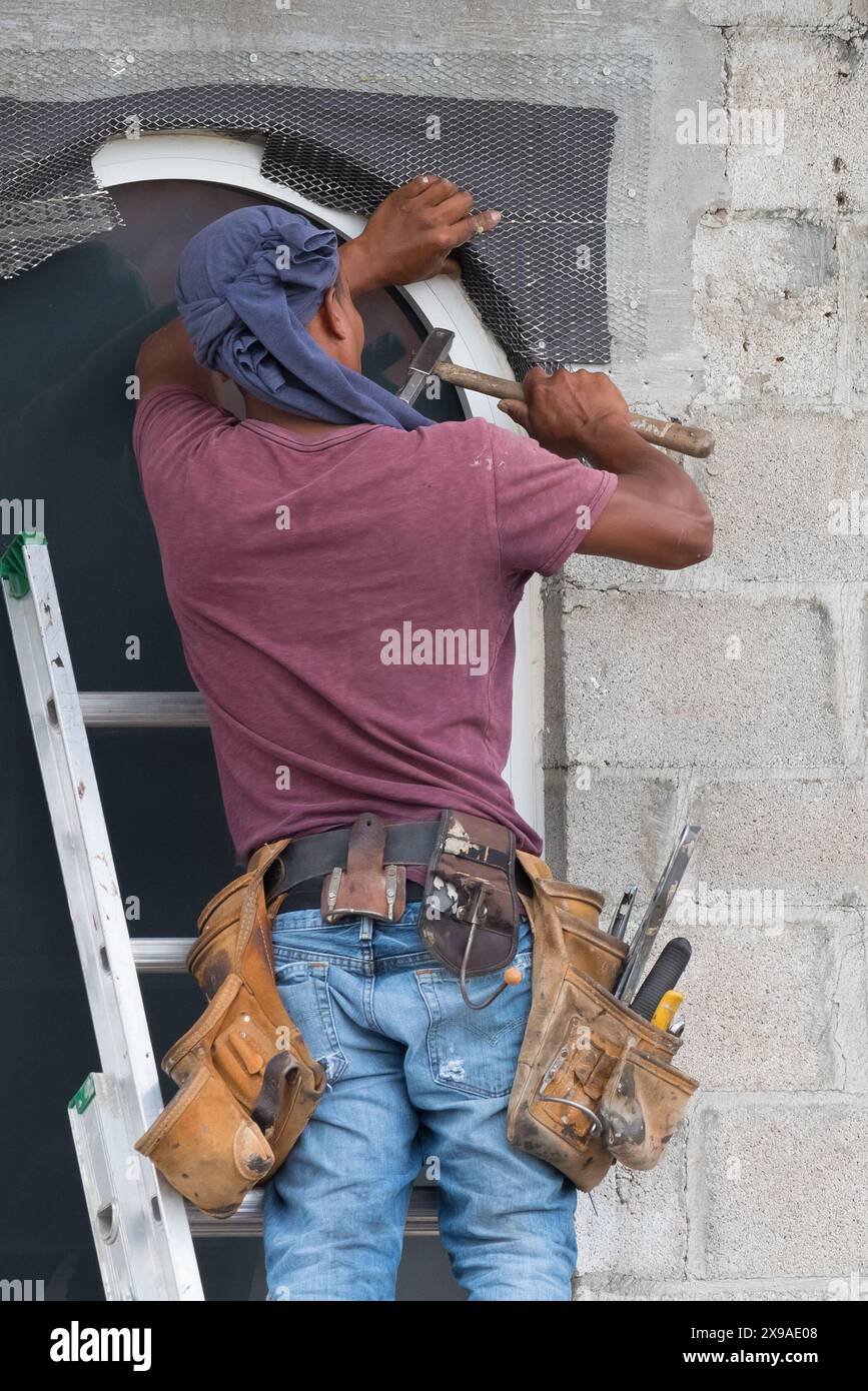 Construction worker on a ladder Stock Photo - Alamy