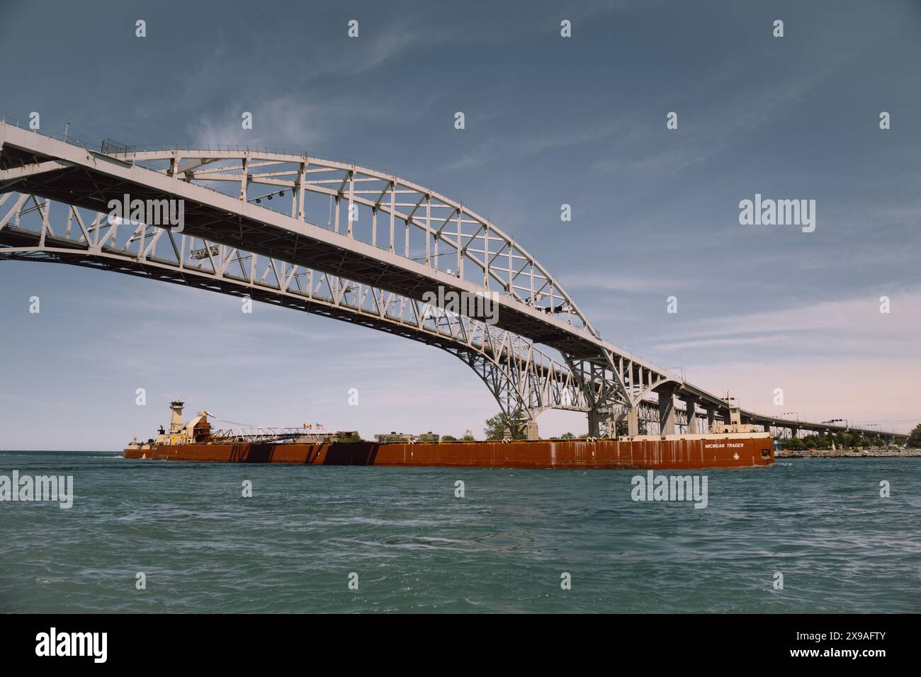 Michigan Trader, a self-unloading bulk carrier ship, passes under the ...