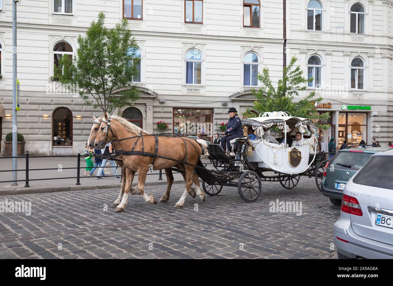 LVIV, UKRAINE - May. 18, 2024: A horse-drawn stagecoach is seen in the ...