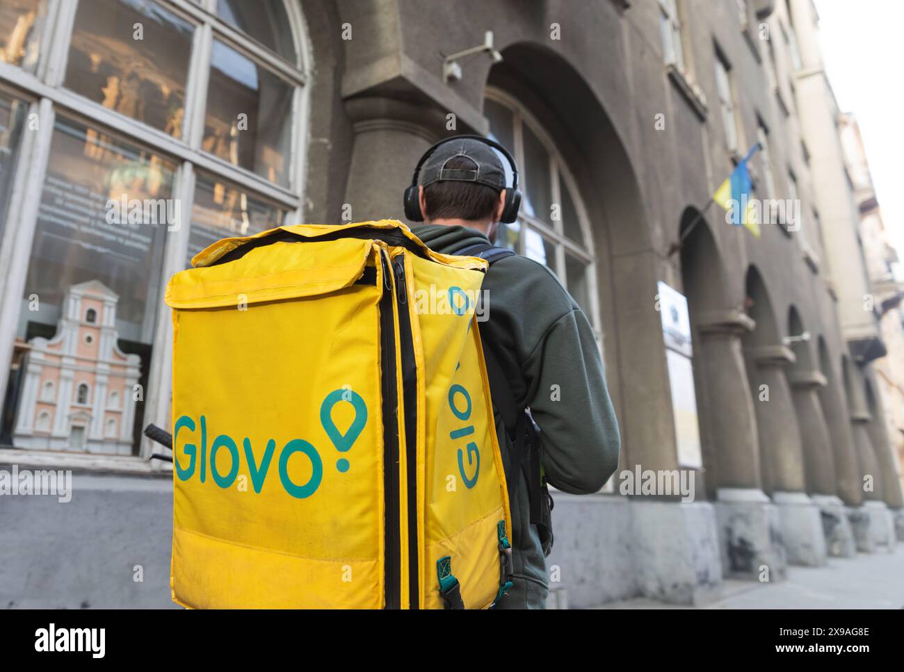 LVIV, UKRAINE - May. 18, 2024: A Glovo food delivery service courier is ...