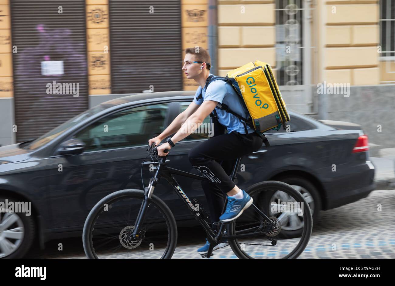 LVIV, UKRAINE - May. 18, 2024: A Glovo food delivery courier is seen on ...