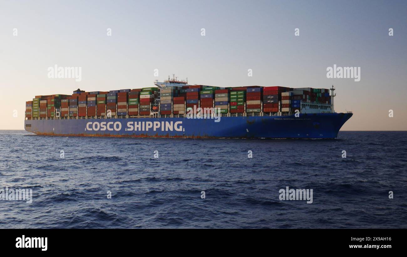 Red Sea, Egypt. A Chinese cargo ship - Cosco Himalayas - sails south ...