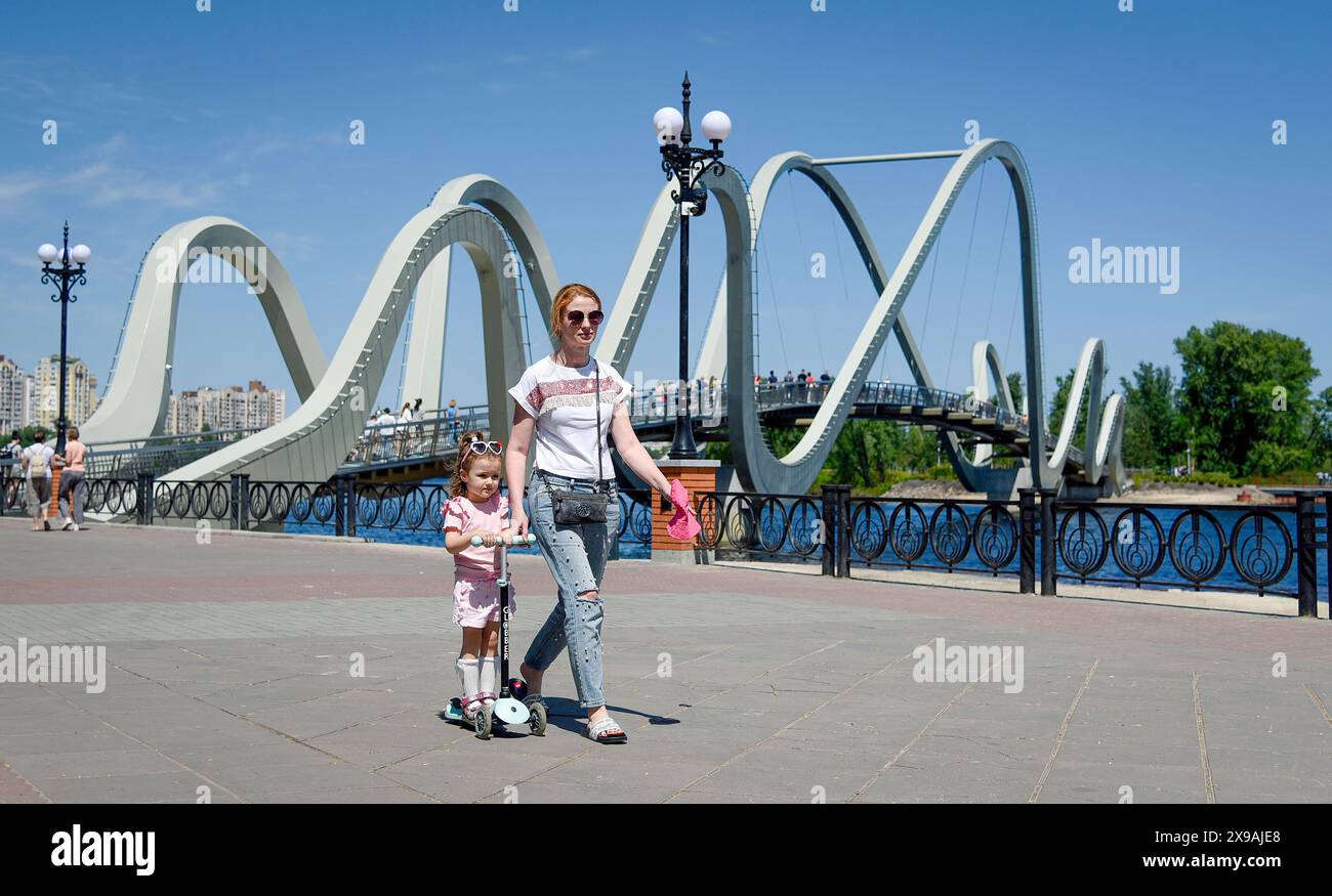 KYIV, UKRAINE - MAY 27, 2024 - A woman and girl walk past the new ...