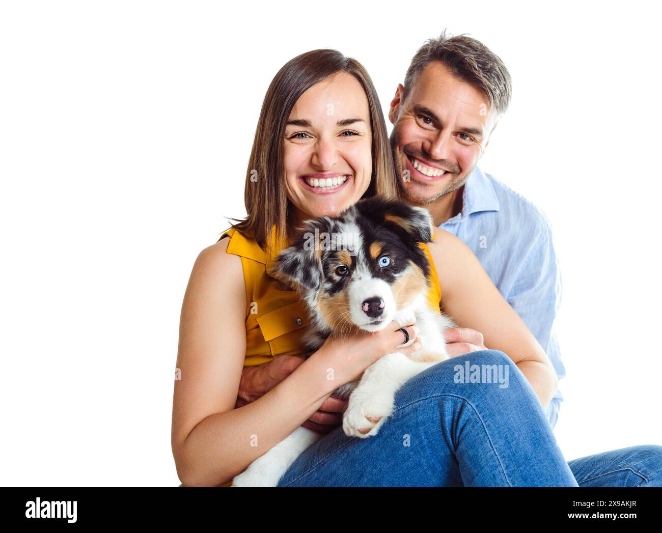 Handsome couple with her Australian Berger puppy on studio Stock Photo ...