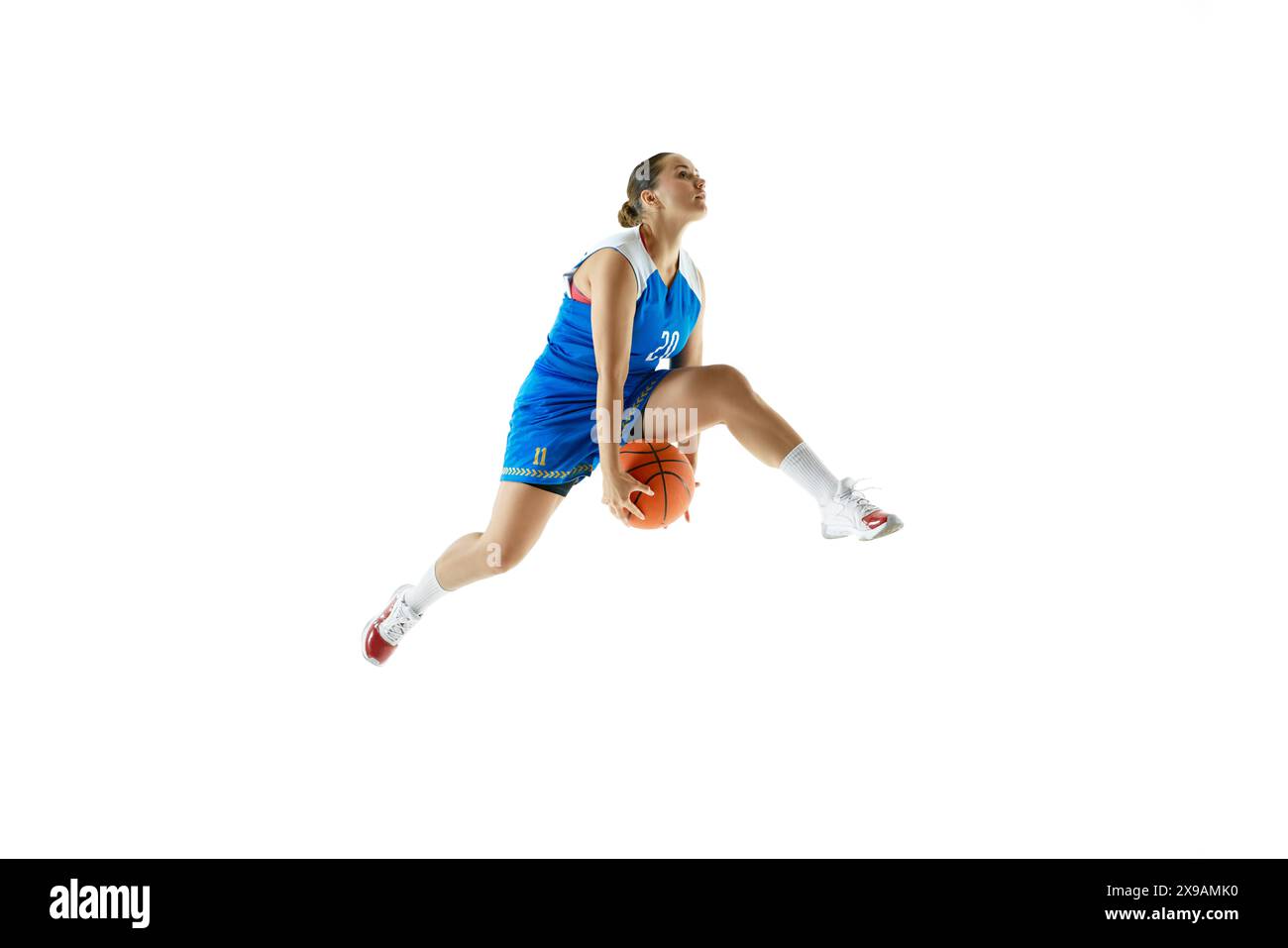 Dynamic portrait of female basketball athlete jumping in action to ...