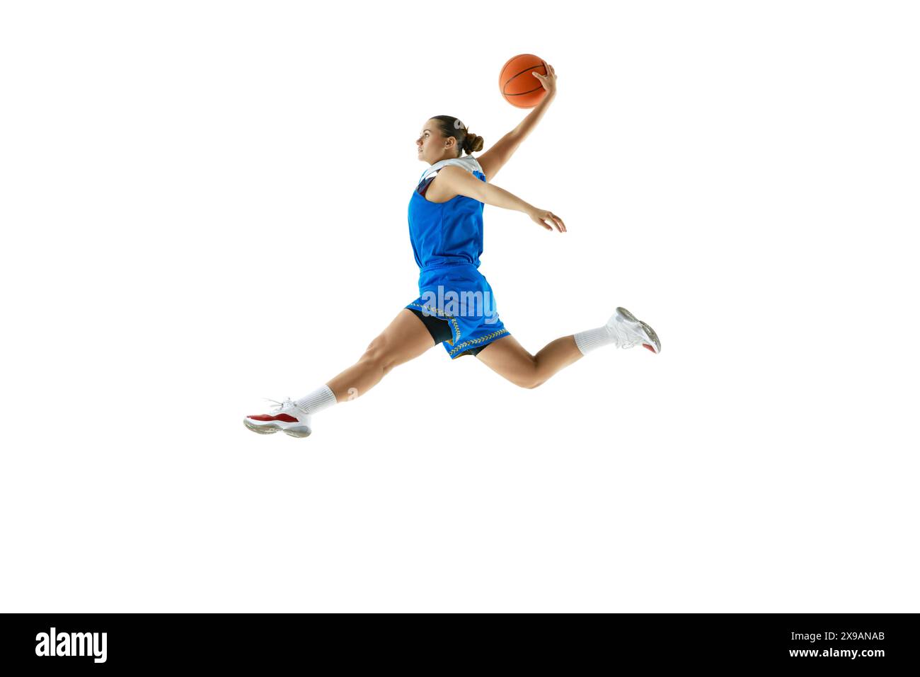 Dynamic photo of young woman, basketball player leaping in mid-air to ...