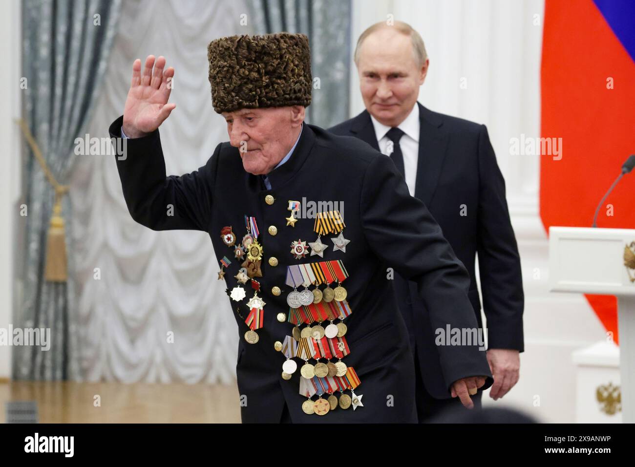 Russian President Vladimir Putin, right, looks at World War Two, 100-year-old veteran Ibragim ...