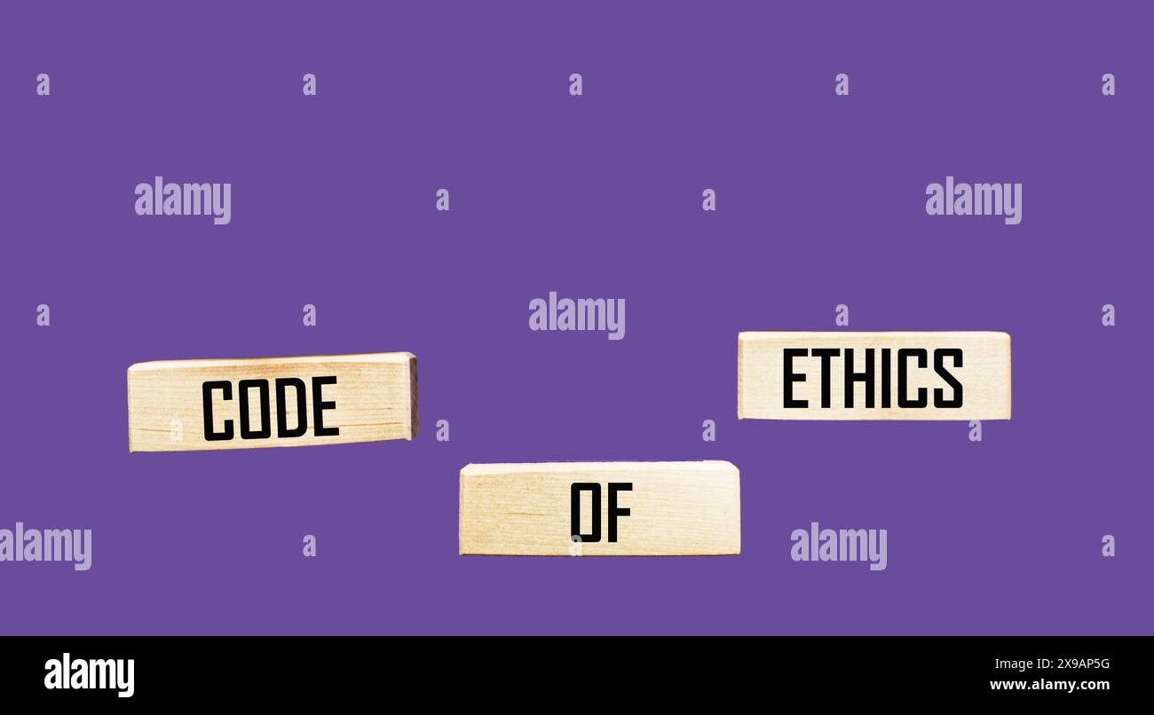 The word code of ethics is written on a wooden block on a beautiful ...