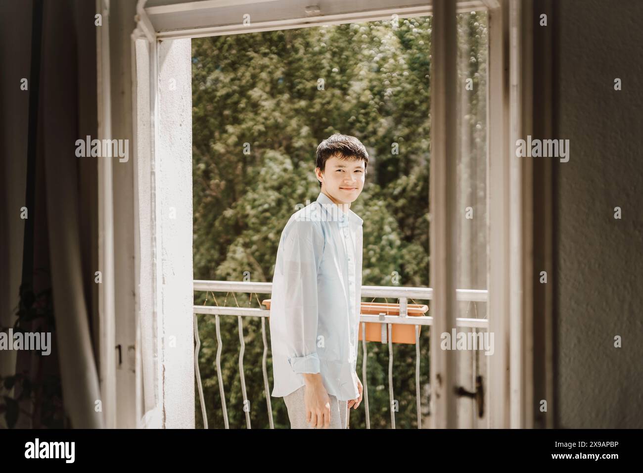 Boy standing balcony hi-res stock photography and images - Alamy